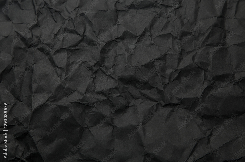 Texture of black crumpled paper. Dark paper background with chaotic bends. A sheet of black ...