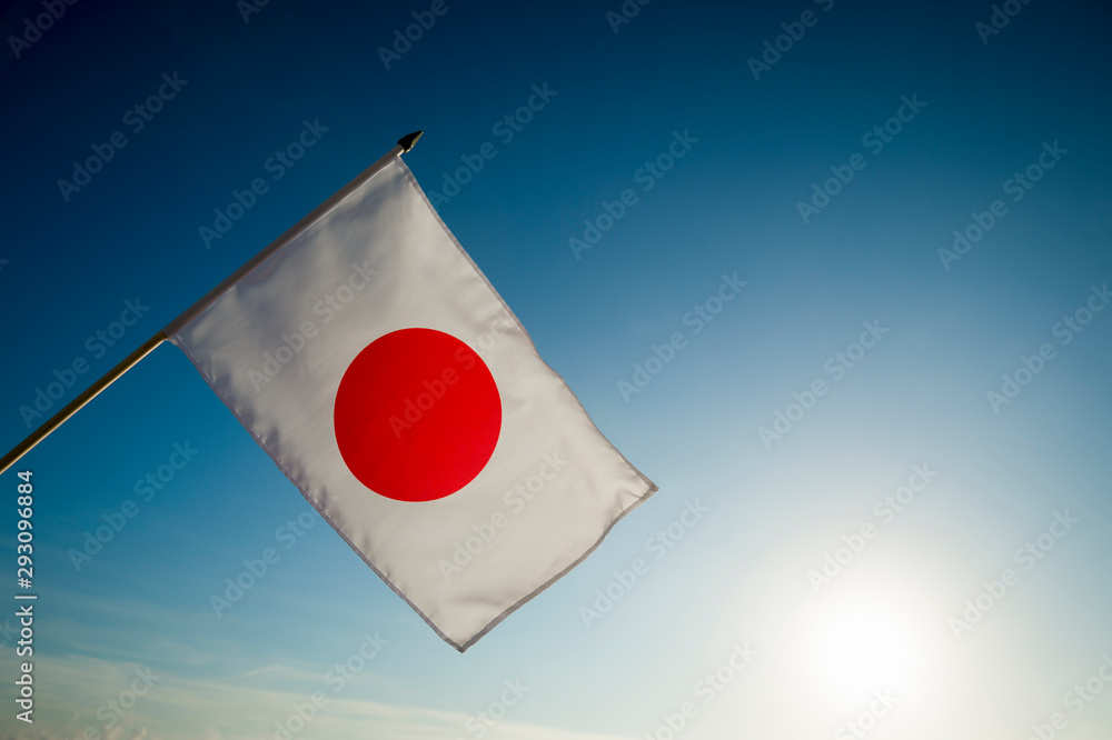 Golden sunrise view of Japanese flag hanging in clear sky with ...