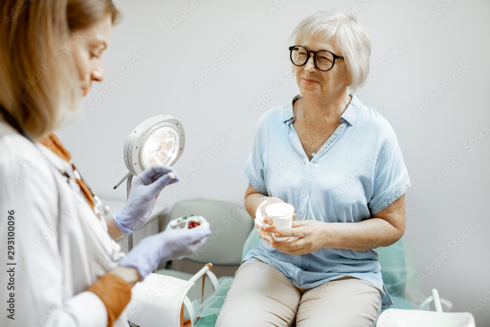 Senior woman sitting on the gynecological chair during a medical ...