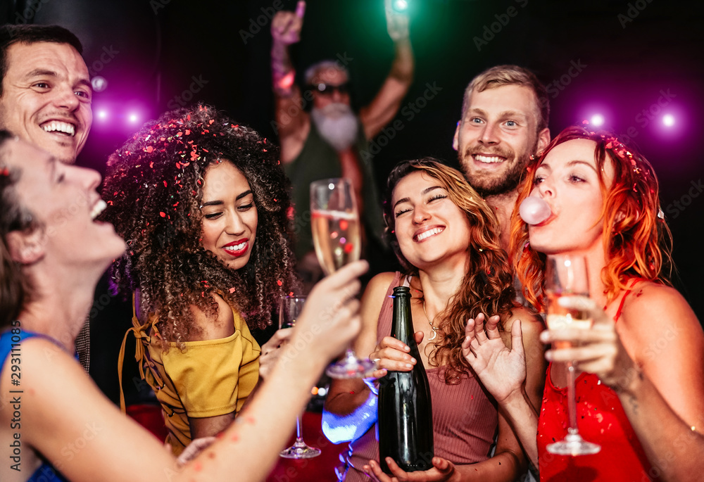 Happy friends making party drinking champagne in the nightclub - Young ...