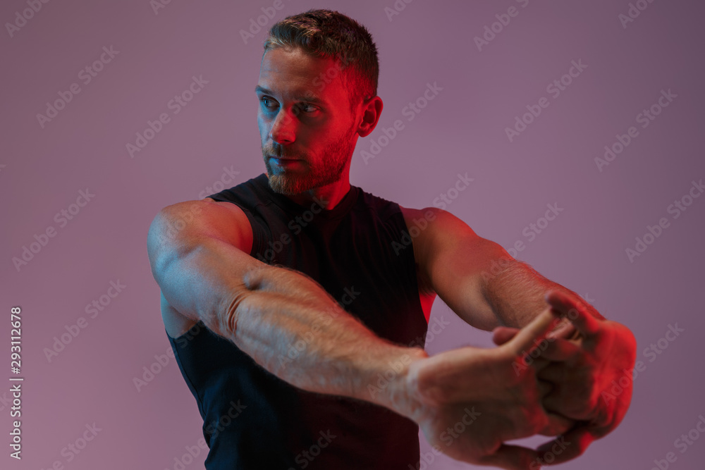 Sports man posing make stretching exercise. Stock Photo | Adobe Stock