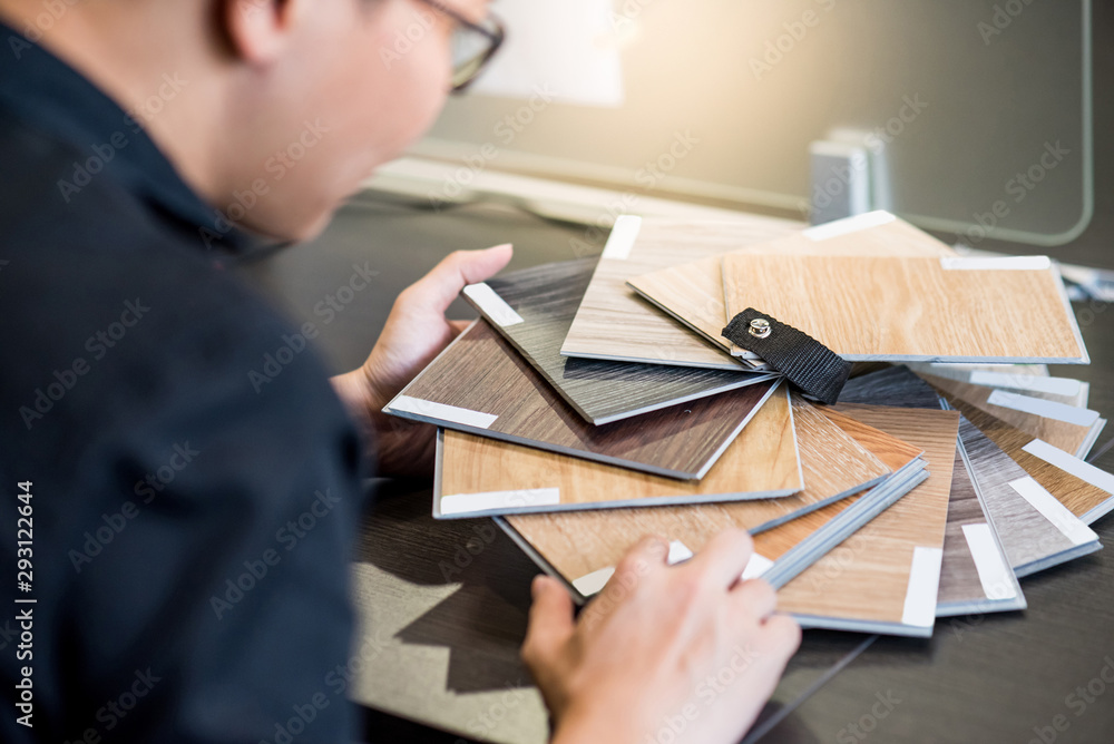 Male architect or interior designer holding wooden color swatch ...