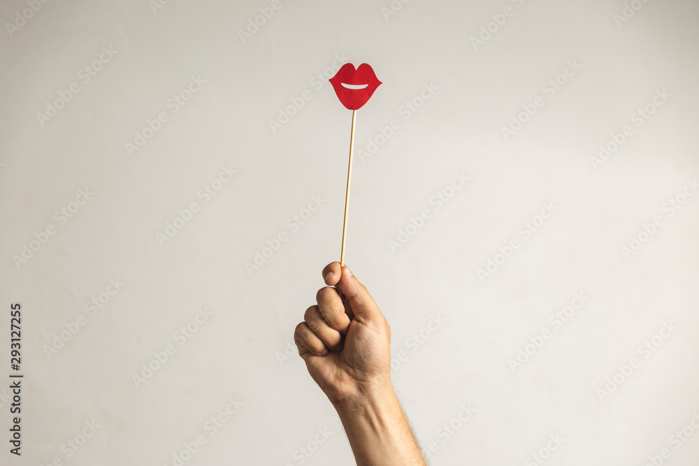 Hand holding Photo booth props, Red lips and rising it up Stock Photo ...
