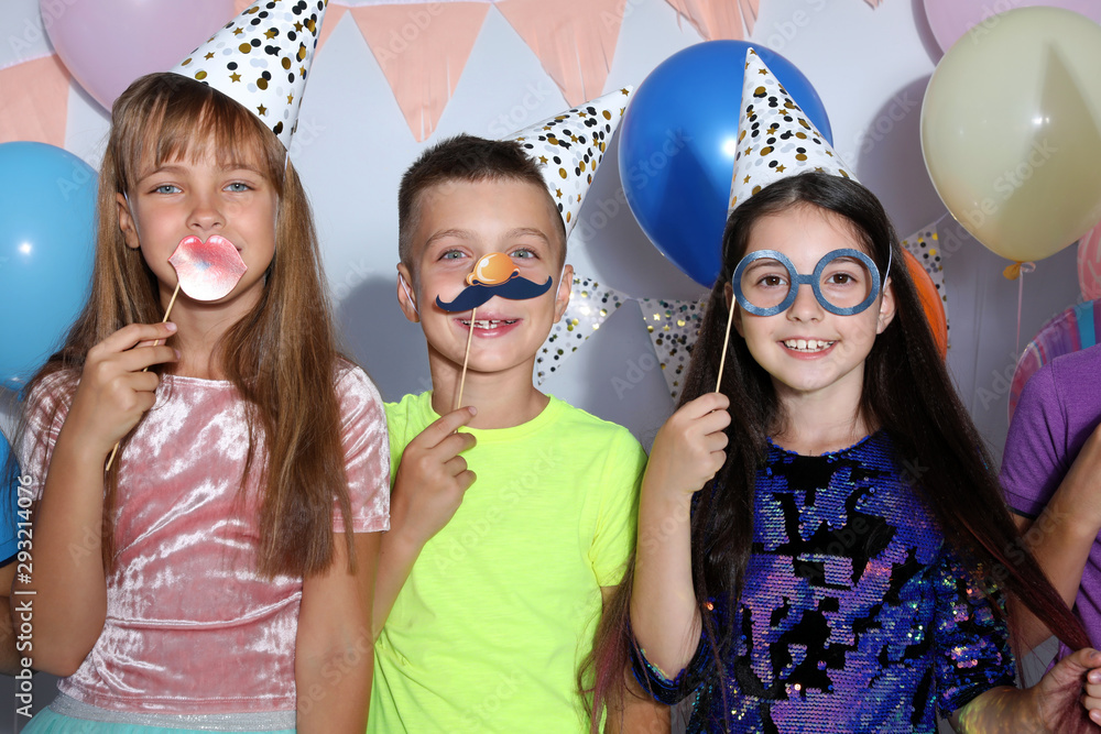 Happy children with photo booth props at birthday party indoors Stock ...