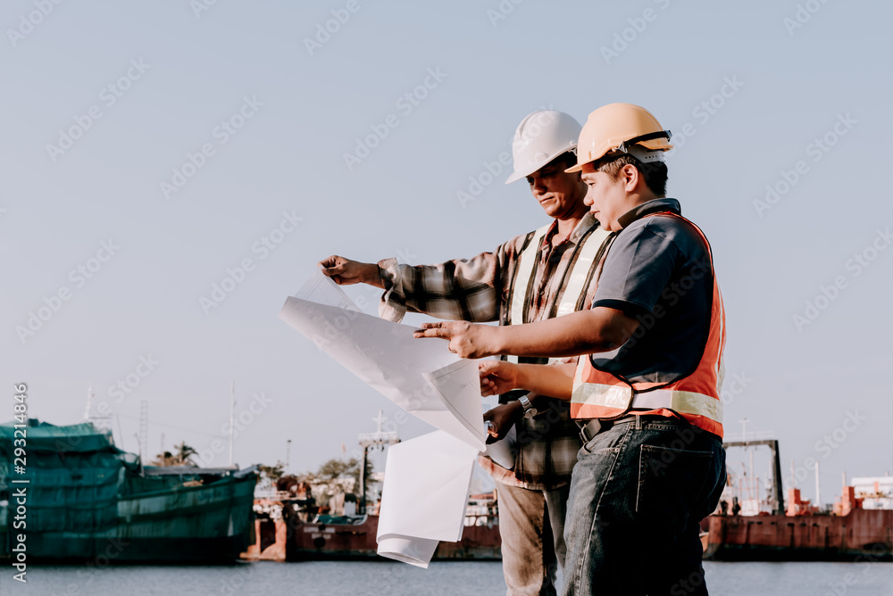 Engineers, technicians Asian middle aged man on the dock helping to see ...