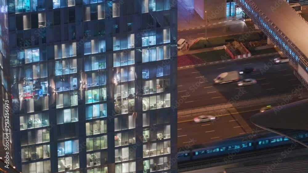 Night view of office and apartment building with traffic on highway ...