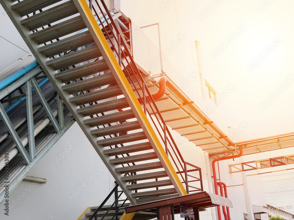 Stairwell fire or emergency exit on wall of building with sunlight ...