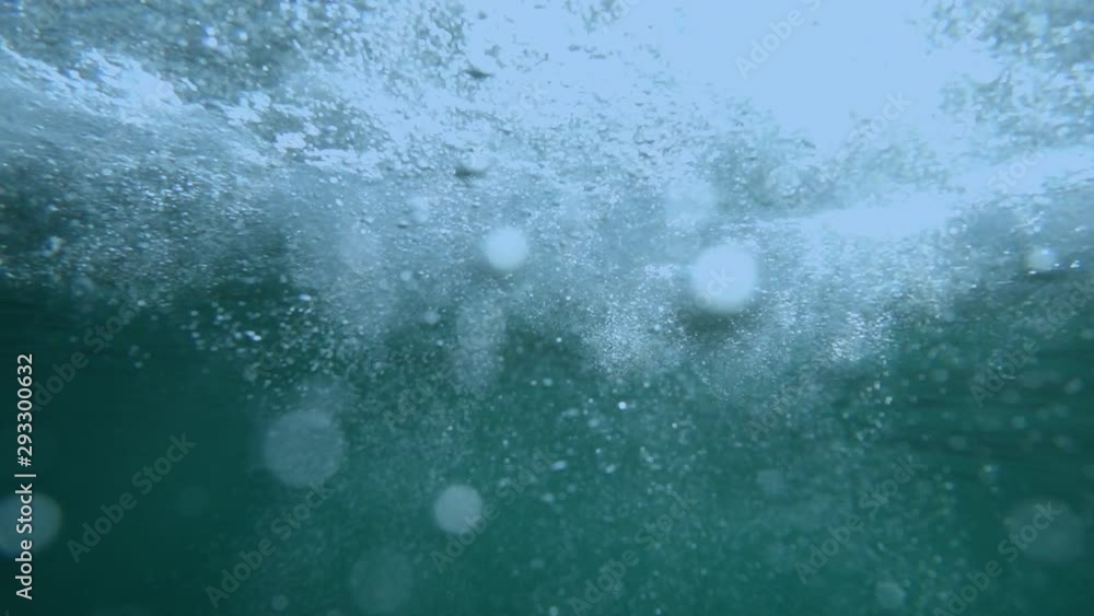 Bubbles rise from the depth to the surface in slow motion. They ...