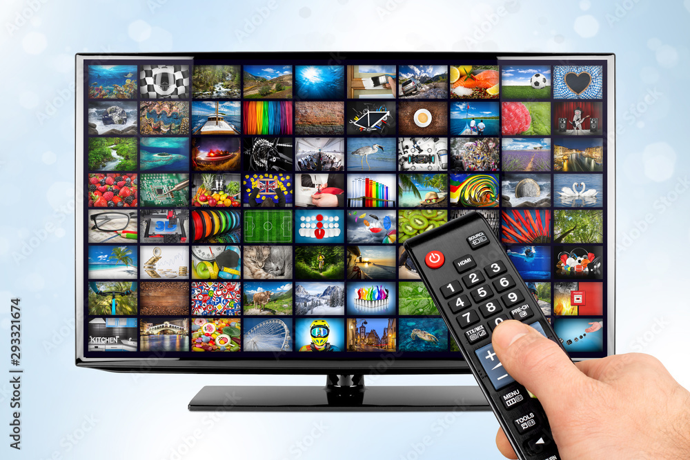 hand with remote on black flat tv screen display with picture movie ...