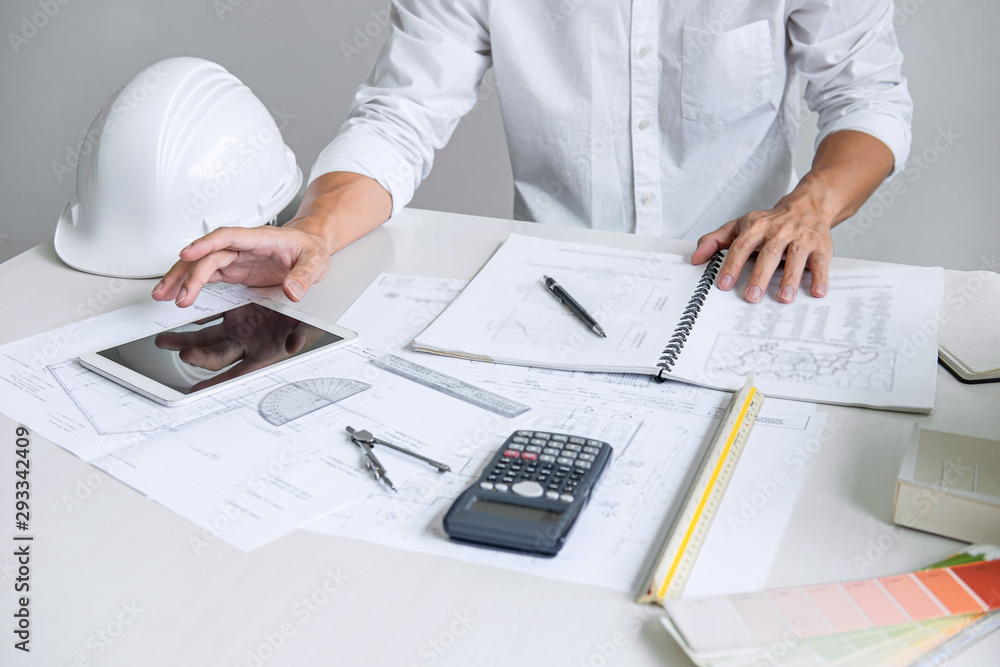 Architect working on blueprint, Engineer working with engineering tools ...