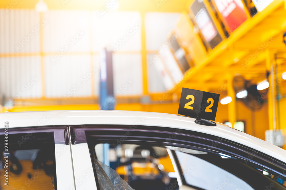 The white luxury vehicle is parked waiting for repair or inspection of ...