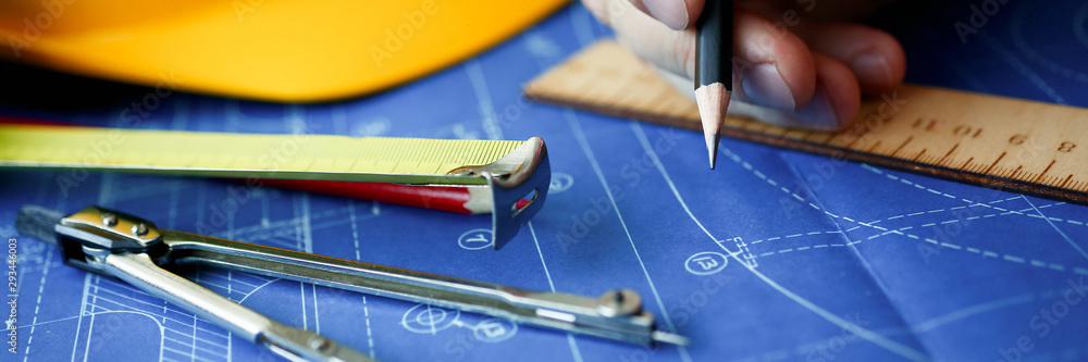 Male hand holding pencil in hand. Engineering blueprint design for ...