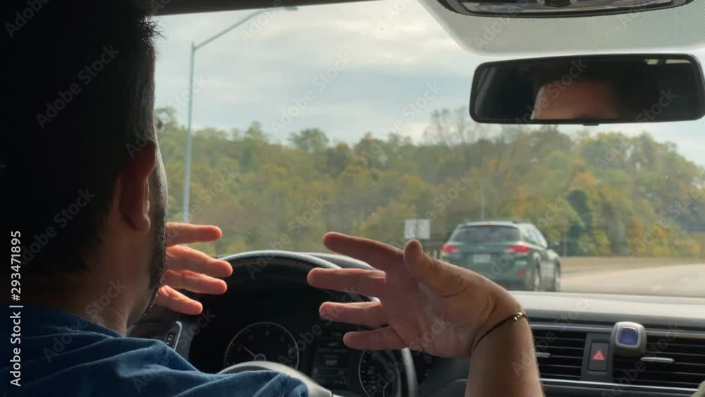 A male millennial driver experiences road rage behind the wheel on the ...