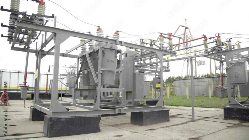 Air high-voltage switches. Electrical poles with wires and insulators ...