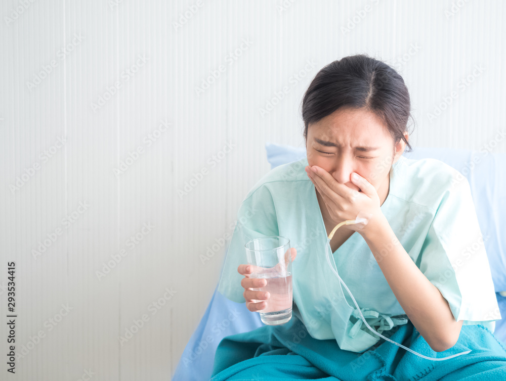 A sick person, a woman with a glass of water and coughing in a hospital ...