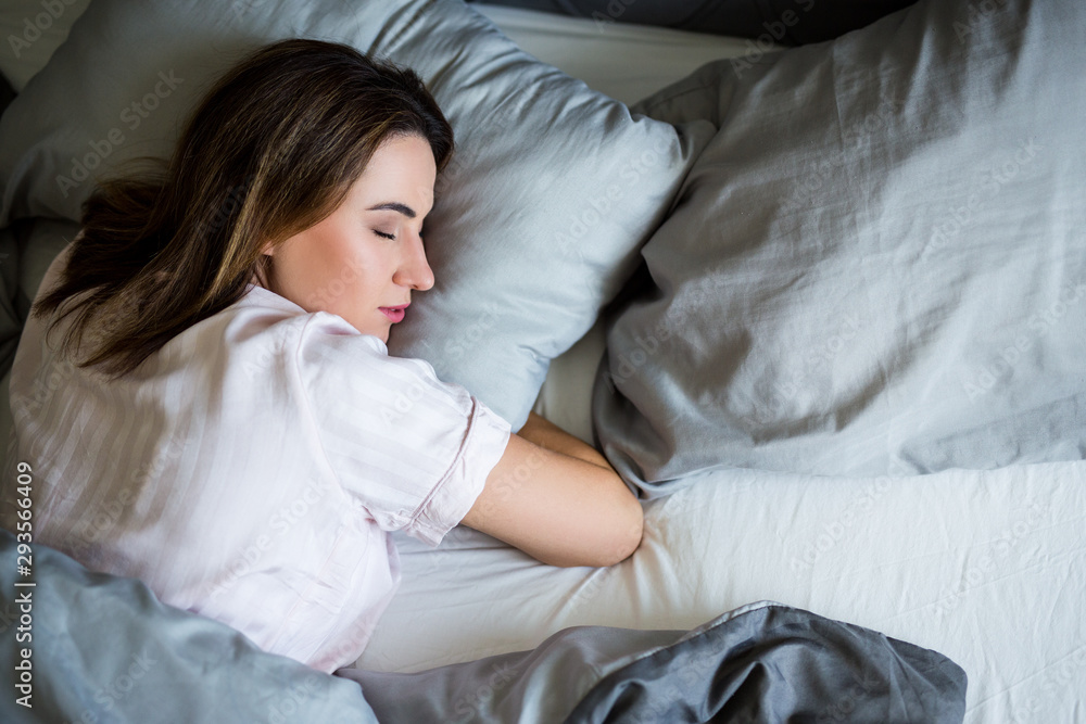 good night or morning concept - beautiful woman sleeping in her bed ...