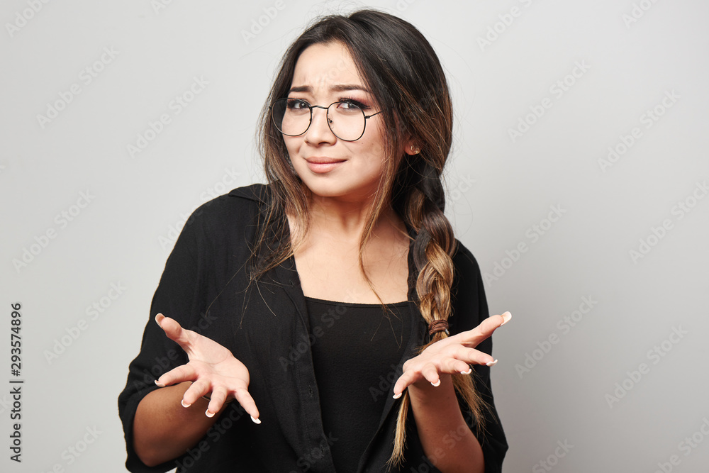Portrait of perplexed Asian Kazakh girl with a dazed face expression ...