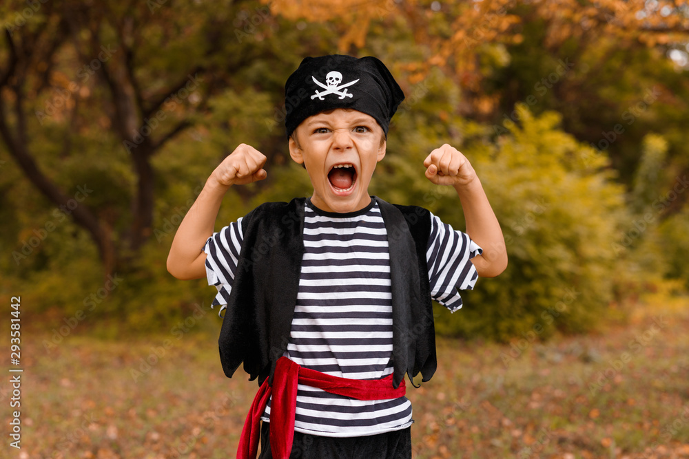 Foto de Little boy in pirate costume showing strength do Stock | Adobe ...