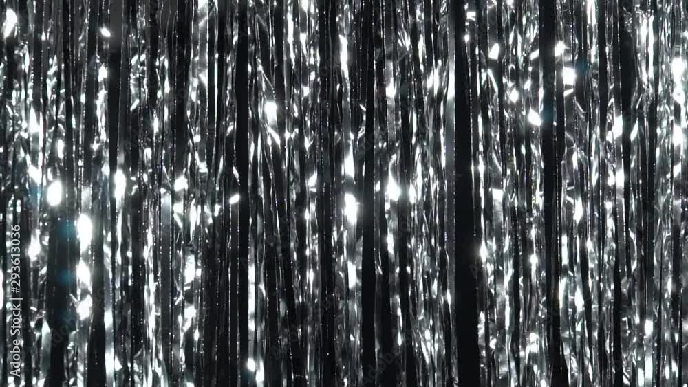 Silver rain from tinsel. Dynamic background in shining lights and ...