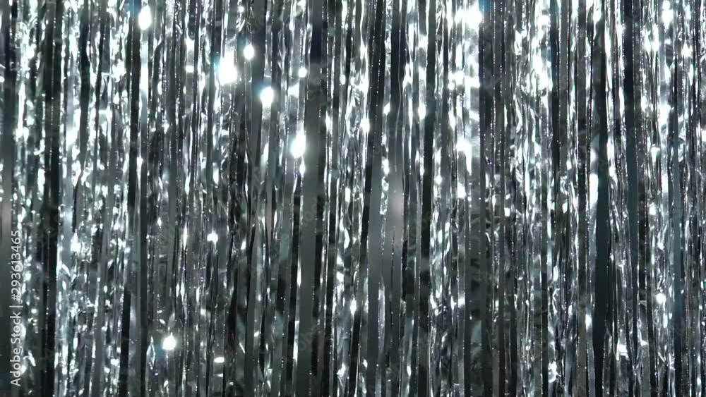 Silver rain from tinsel. Dynamic background in shining lights and ...