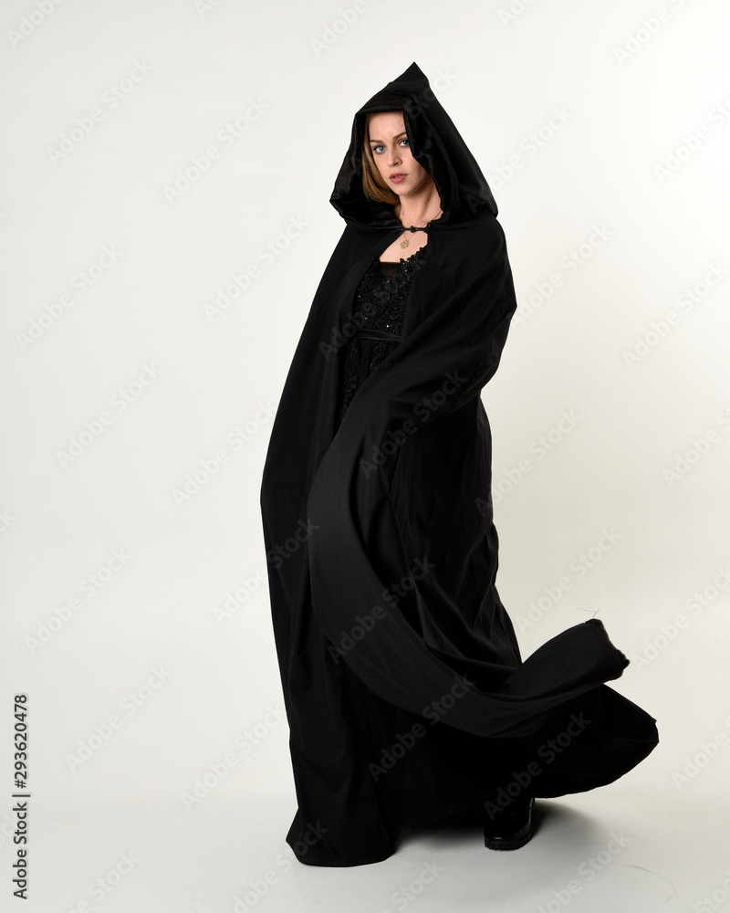 full length portrait of blonde girl wearing long black flowing cloak ...