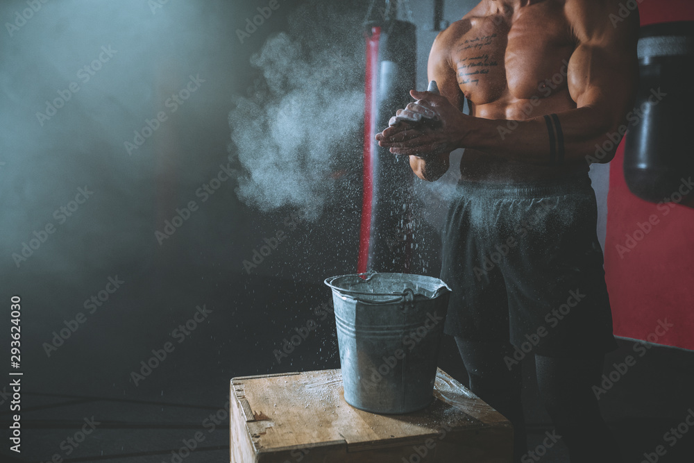 Details closeup bodybuilding man using the powder on his hands ...