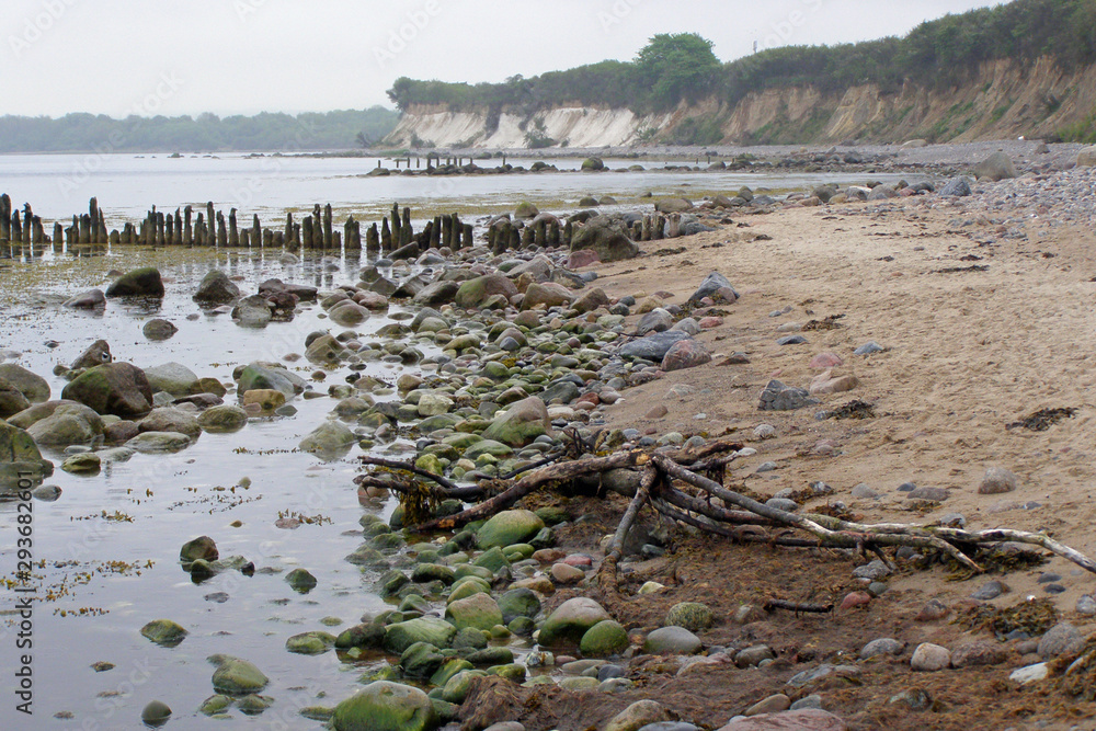 Beautiful scenery with a pebbles beach, quiet water and weathering ...
