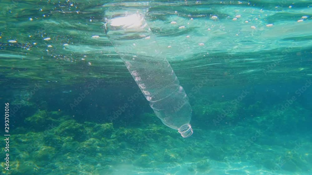 Plastic bottle being dumped in to the sea/ocean. Pollution in ocean is ...