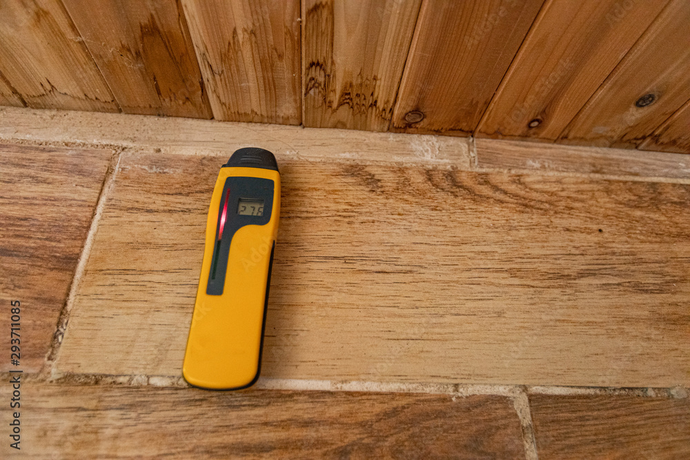 Indoor damp & air quality (IAQ) testing. A timber moisture detector is ...