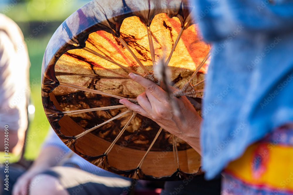 Sacred drums during spiritual singing. A close up view on the hands of ...