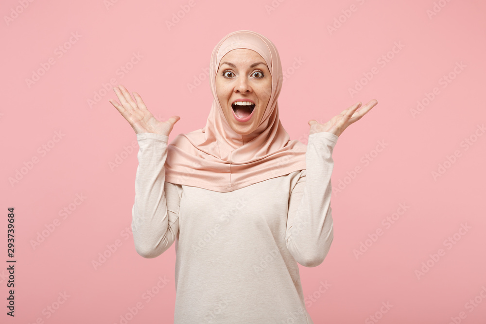 Surprised amazed young arabian muslim woman in hijab light clothes ...