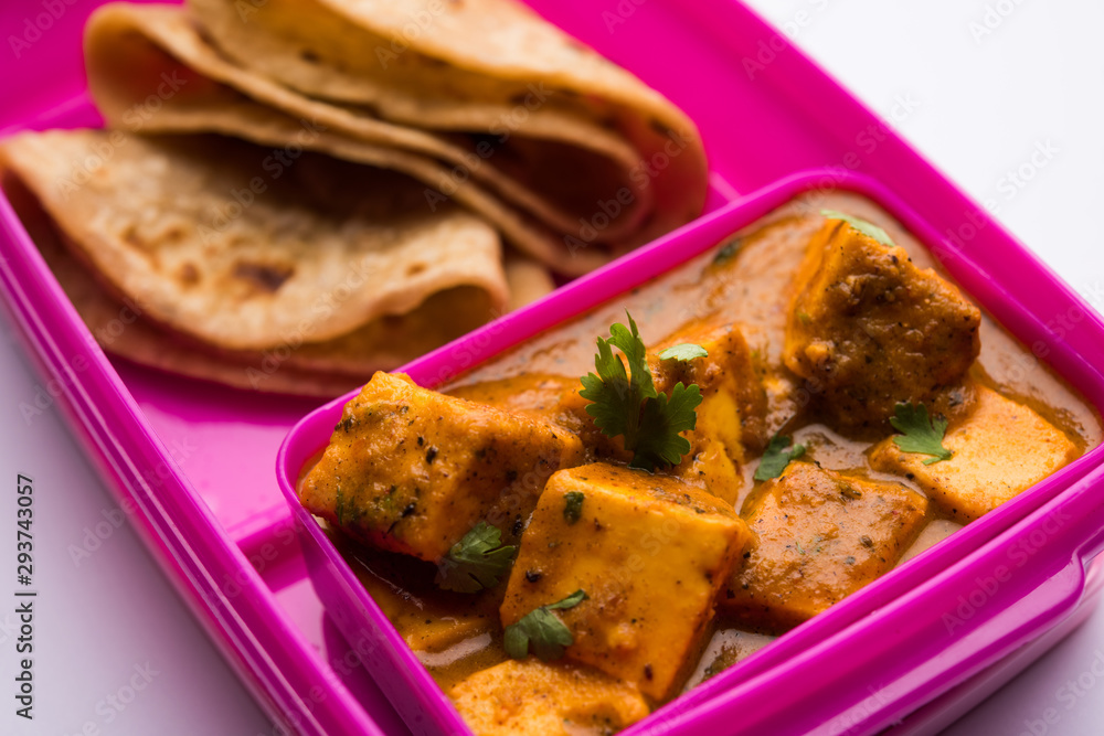Paneer Butter Masala with Roti in lunch box or tiffin, selective focus ...