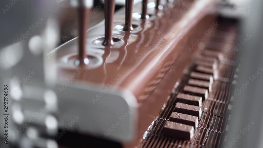 Handheld static close-up shot of small chocolate bars on a conveyor ...
