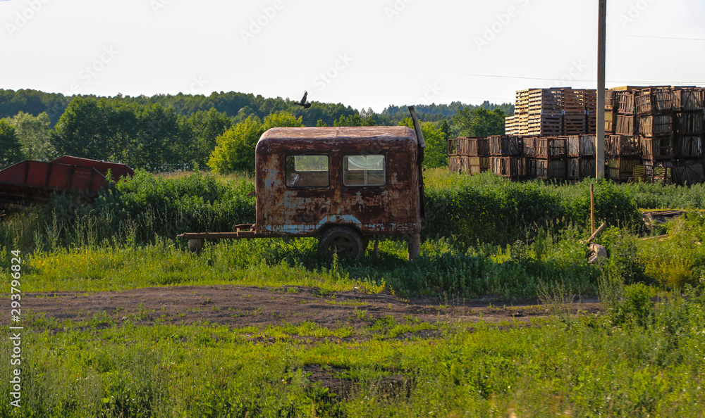 old rusty trailer with manure fertilizer stands in field to fertilize ...