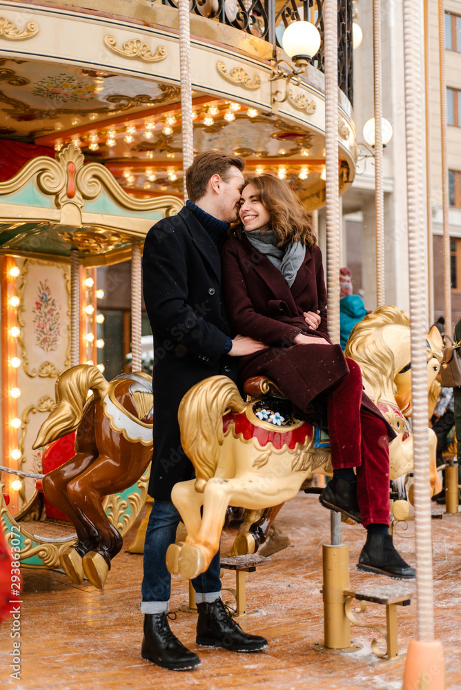 Romantic couple on carousel in winter time Stock Photo | Adobe Stock