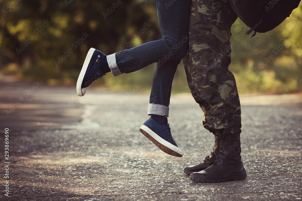 Family and soldier in a military uniform say goodbye before a ...