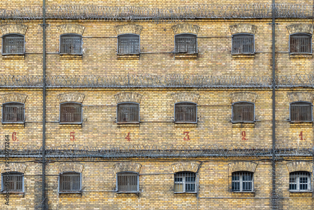 Abandoned jail brick wall and cell windows with bars Stock Photo ...
