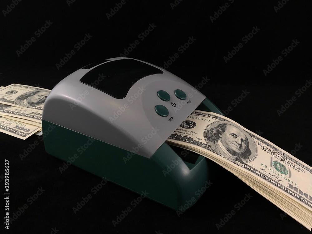 Automatic detector for checking banknotes. Dollars are checked through ...