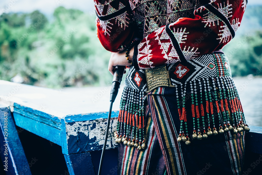 Foto de Midsection of a young lady holding a microphone and wearing a ...