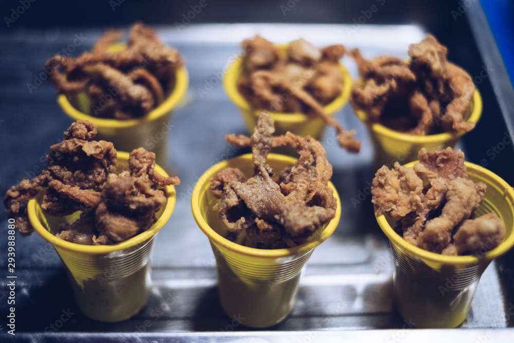 Filipino street food of deep fried crispy breaded chicken strips in a ...