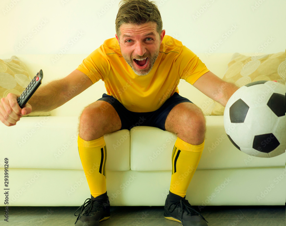 funny and crazy soccer fan man dressed in his team uniform watching ...