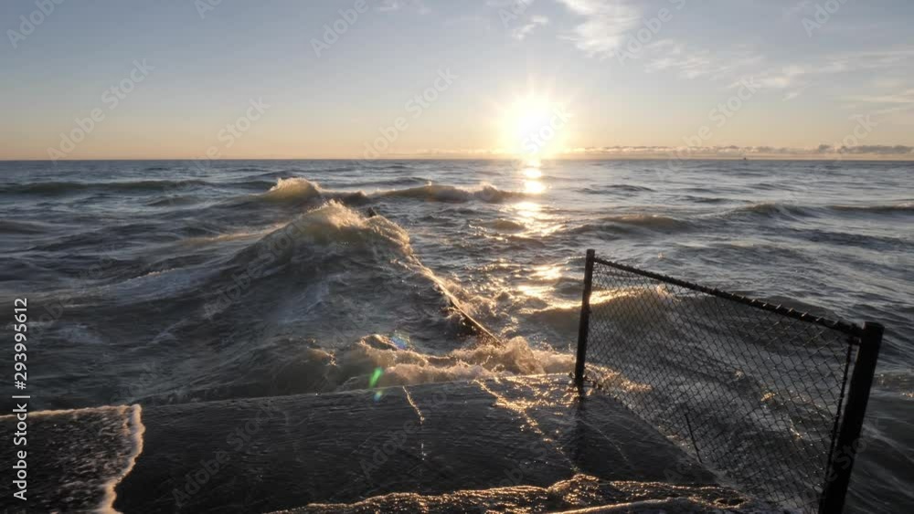 Slow motion seascape clip of the sun reflecting on the water and wet ...