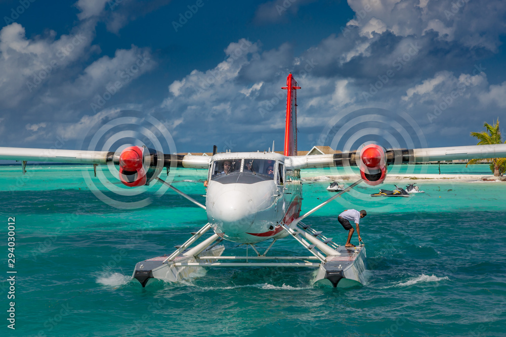 Exotic scene with seaplane on Maldives sea landing. Seaplane taxi on ...