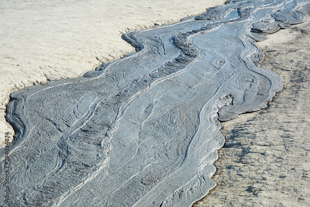 Mud flow from a mud volcano. Cracked mud surface. Mudflow texture with ...
