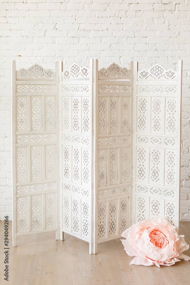 White delicate decorative wood panel with big paper flowers on white ...