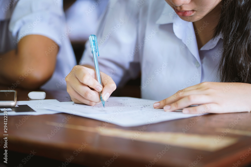 Student hand holding pen writing doing examination in university ,girl ...