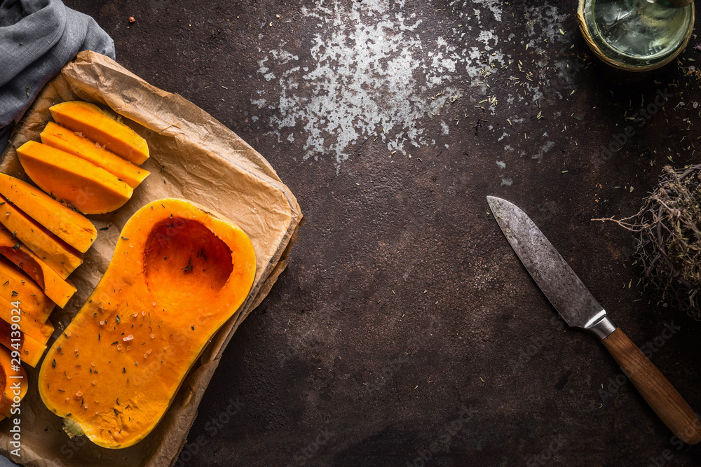 Food background with butternut pumpkin on baking sheet on dark rustic ...