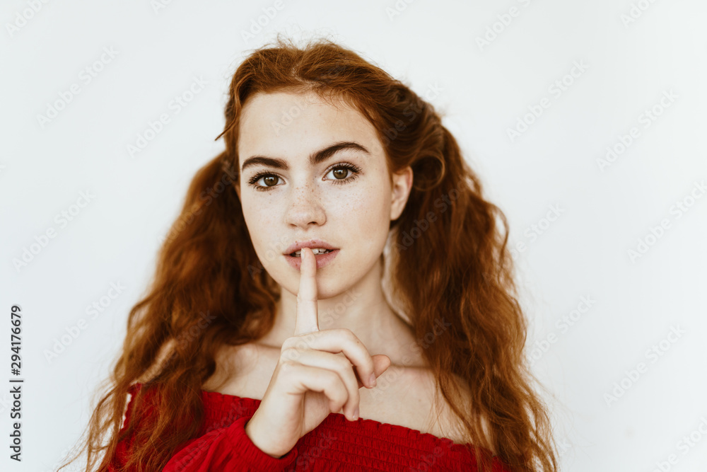 Charming young girl with curly red hair braided in ponytails, with ...