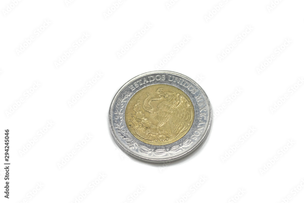 A macro image of a silver and gold Mexican peso coin, shot close up, on ...