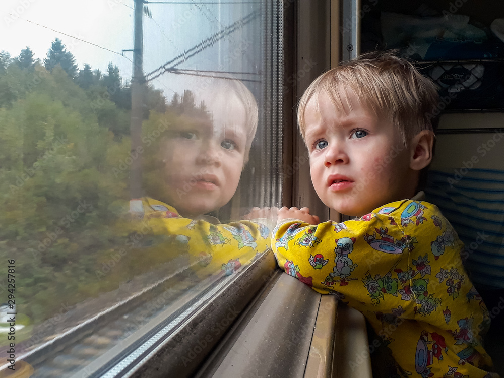 Ilustração do Stock: A bright, cute three-year-old boy riding a train ...